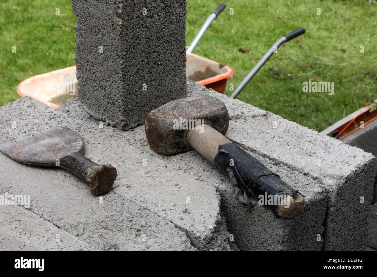 A lump hammer and chisel rest on a pile of foundation stones Stock ...