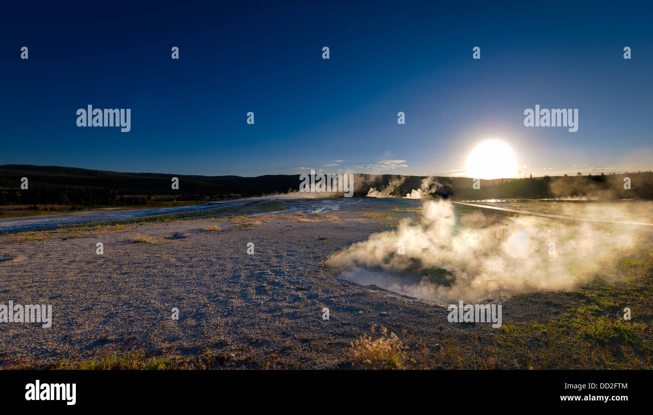 The sun sets behind the steaming hot springs surrounding the Old ...