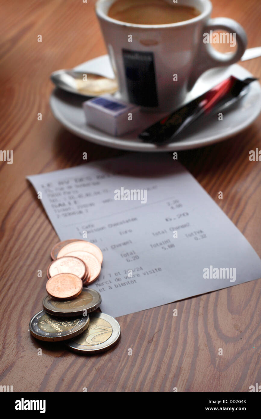 Euro coins next to a coffee cup and receipt Stock Photo - Alamy
