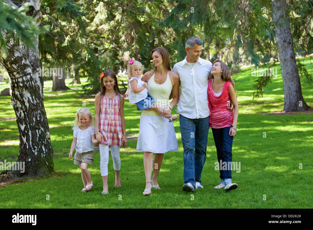 Family Walking Together In A Park; Edmonton, Alberta, Canada Stock ...