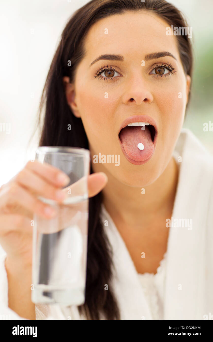 beautiful young woman drinking medication Stock Photo - Alamy