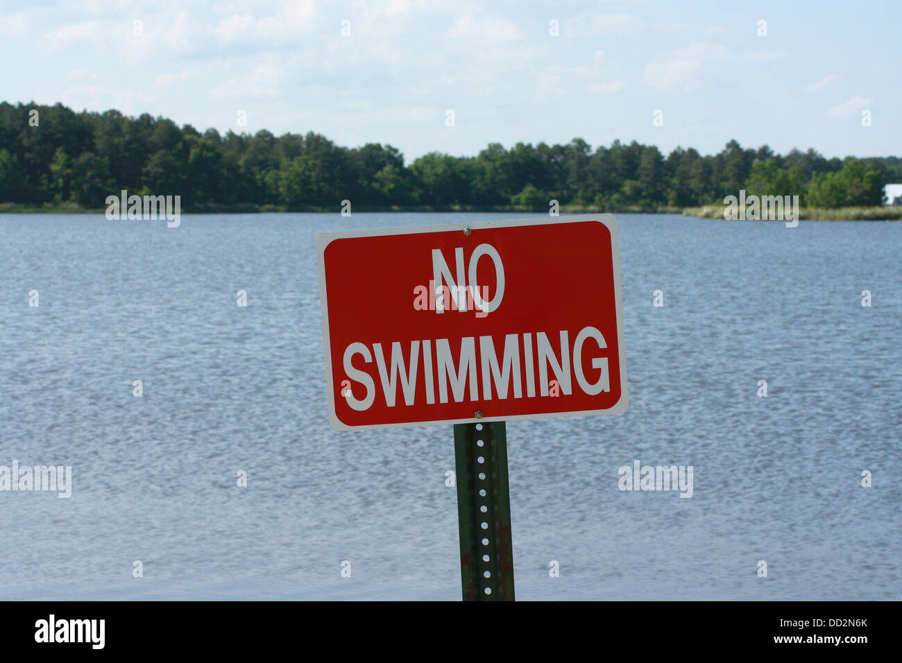 Red sign warning against swimming Stock Photo - Alamy
