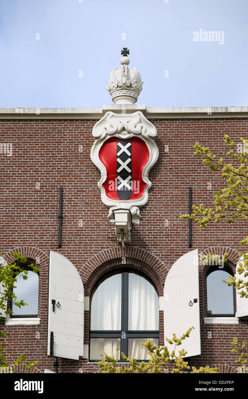 Amsterdam coat of arms and window with white shutters on a historic ...