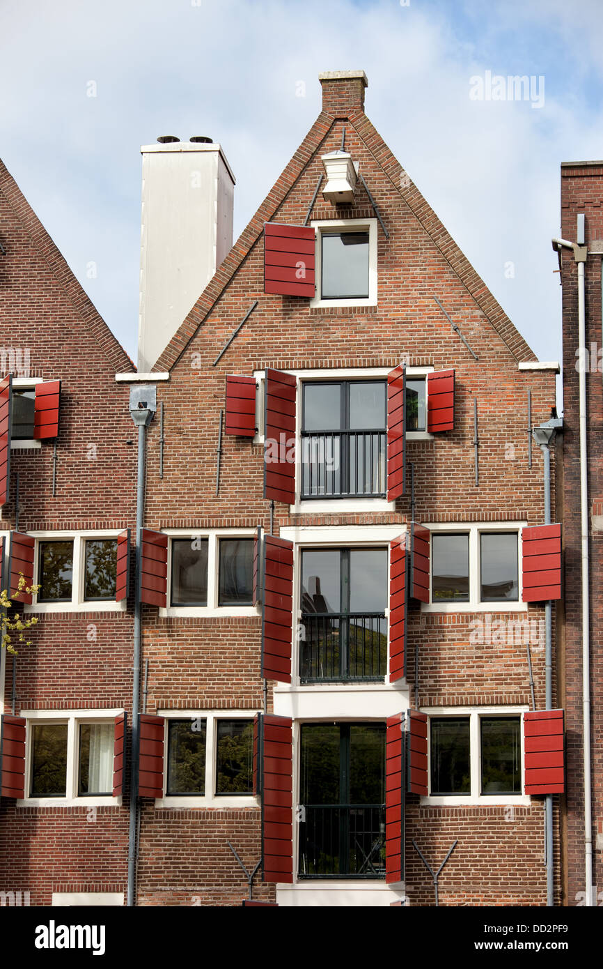 Historic house with red window shutters and simple triangular gable in ...