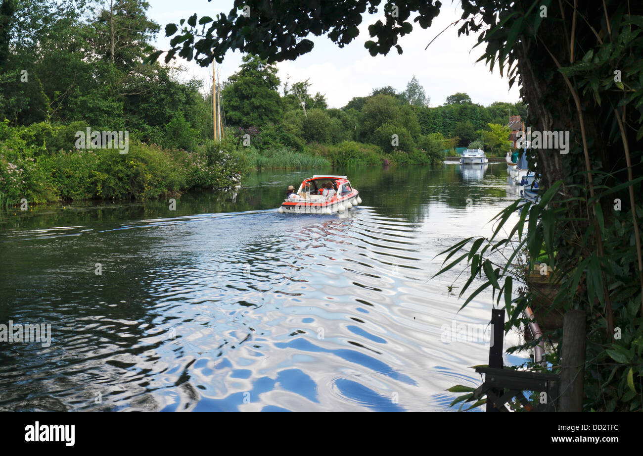 A day launch on the River Bure on the Norfolk Broads at Belaugh, near ...