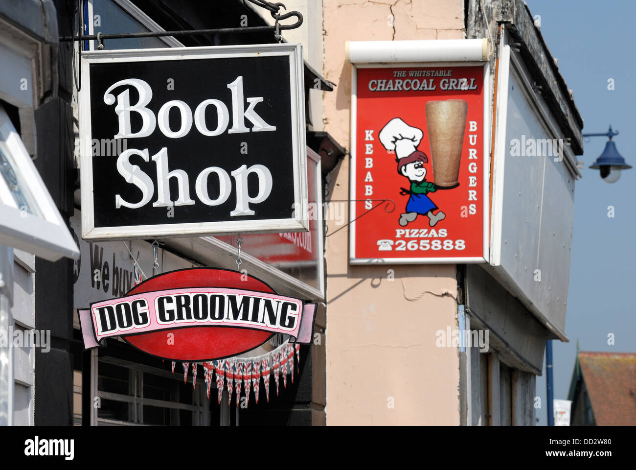 Whitstable, Kent, England, UK. Book shop / dog grooming sign and kebab ...