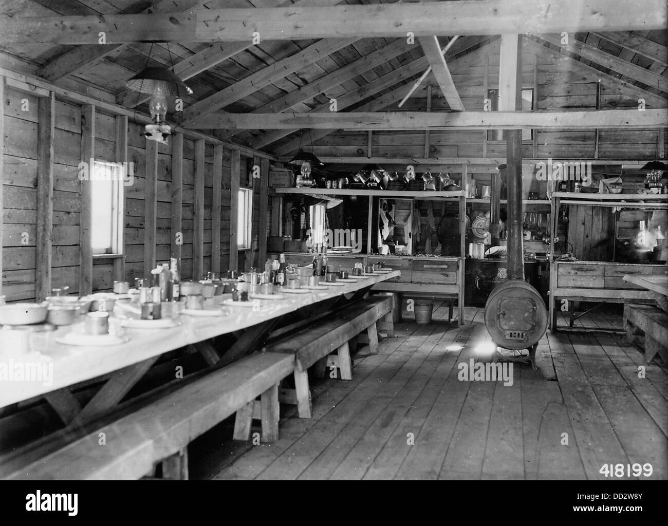 This image shows the mess hall at a logging camp, providing a glimpse ...