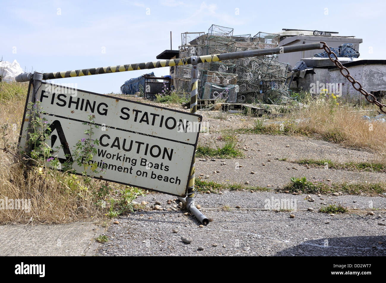 Fishing station sign on pole barrier with fishing equipment on beach ...