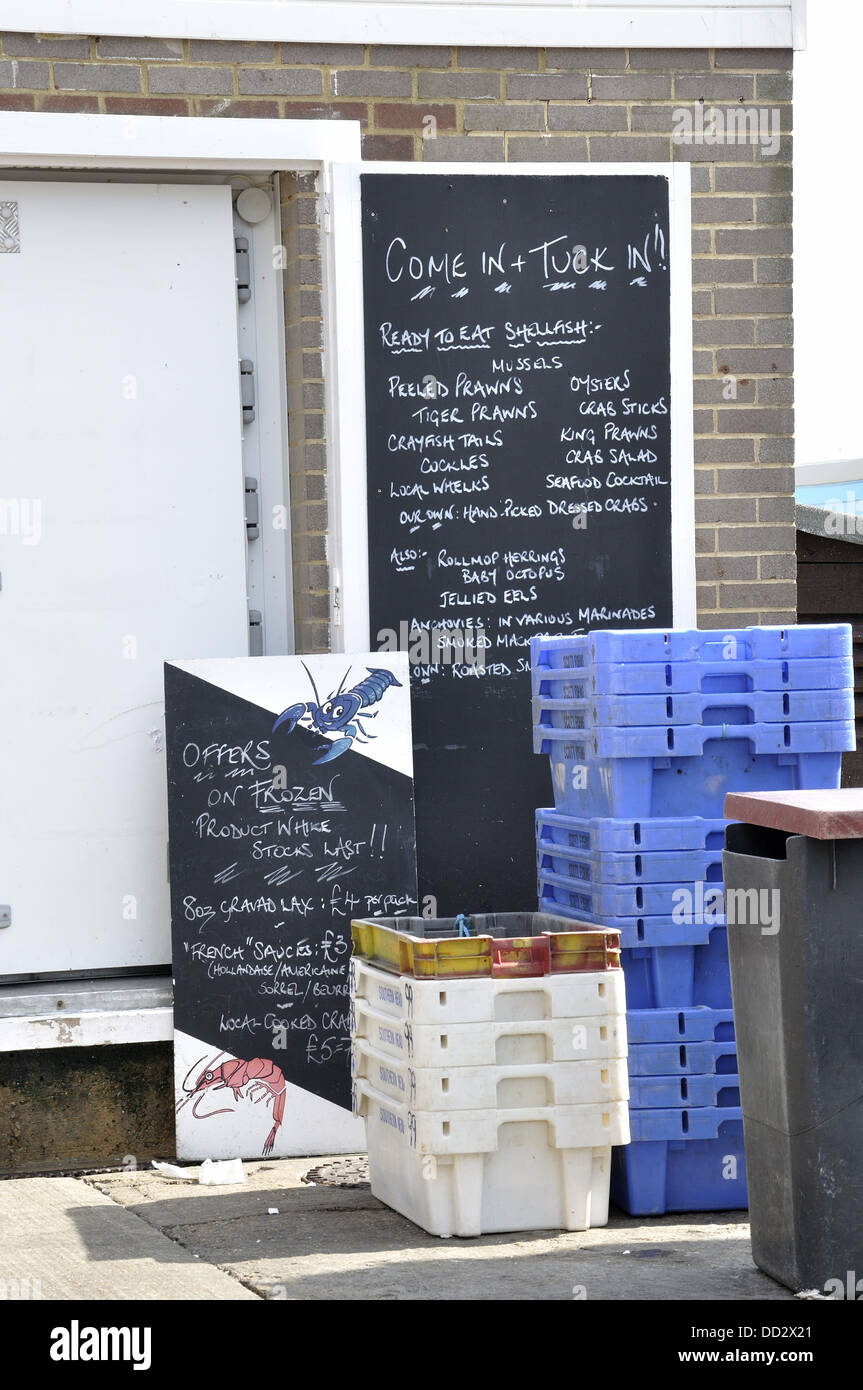 Stacked baskets in front of black board with white signage advertising ...