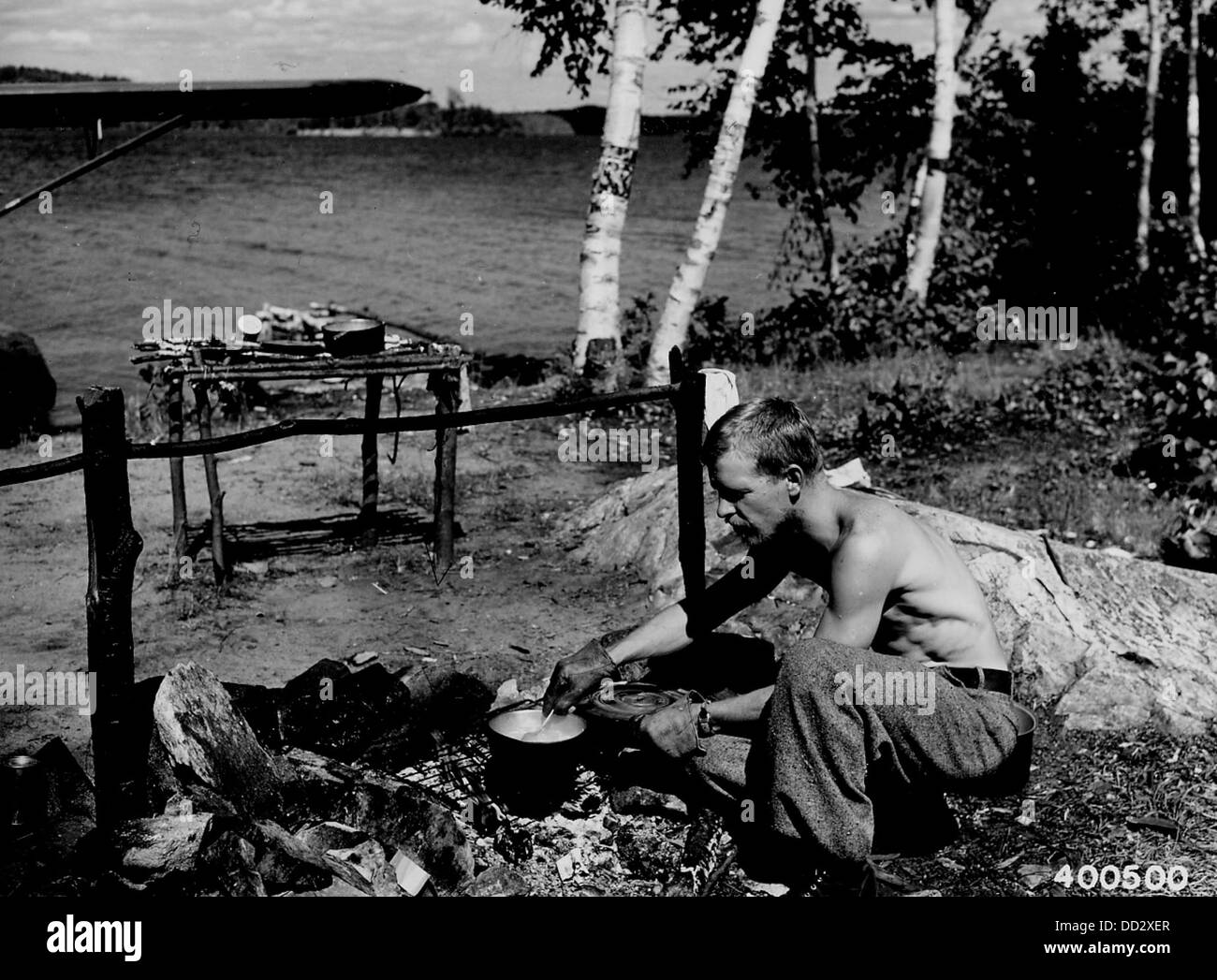 A scene at a canoe camp site where lunch is being prepared. This ...