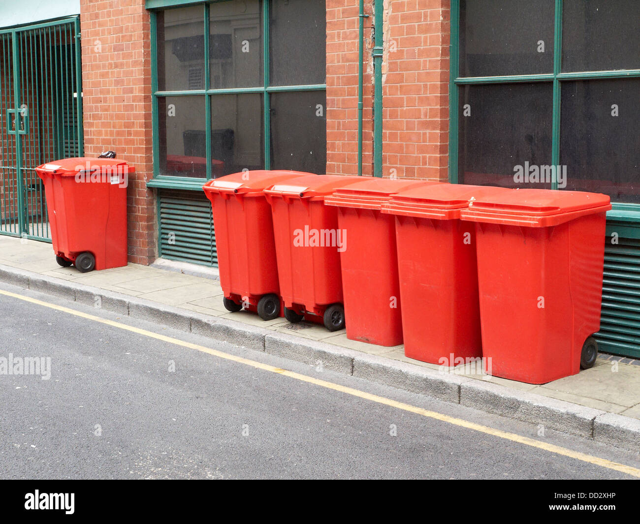 Red litter bins on pavement in Manchester UK Stock Photo - Alamy