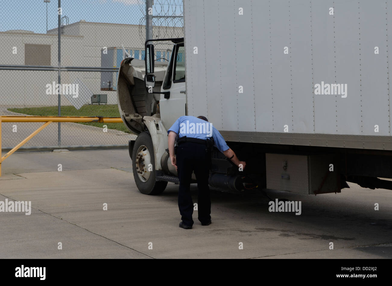 Officer searching vehicle about to enter an American maximum security ...