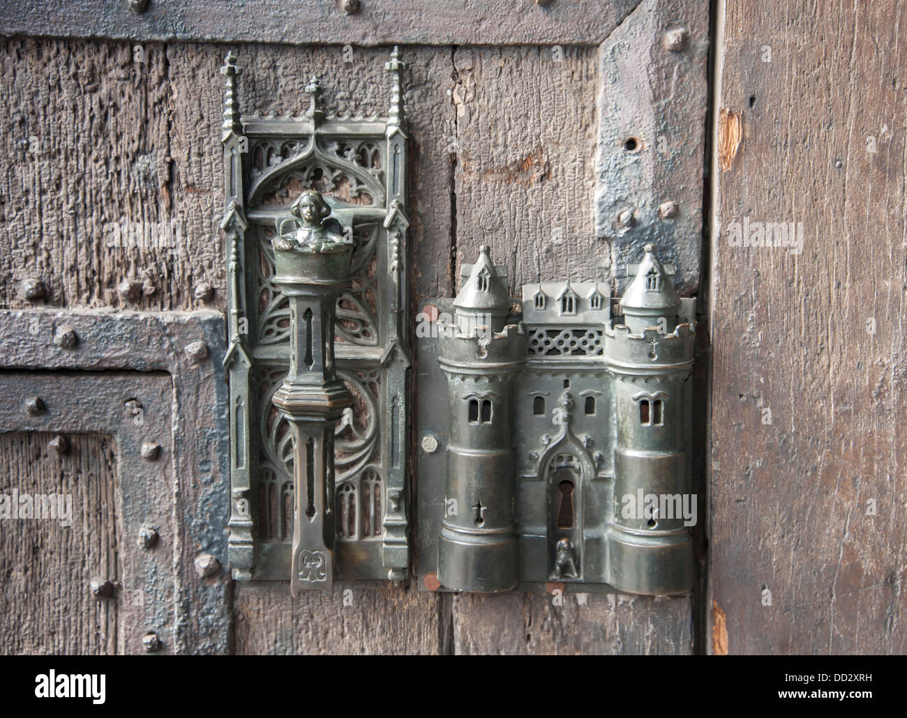 ornate cast iron gothic lock attached to the large oak doorway of mons ...