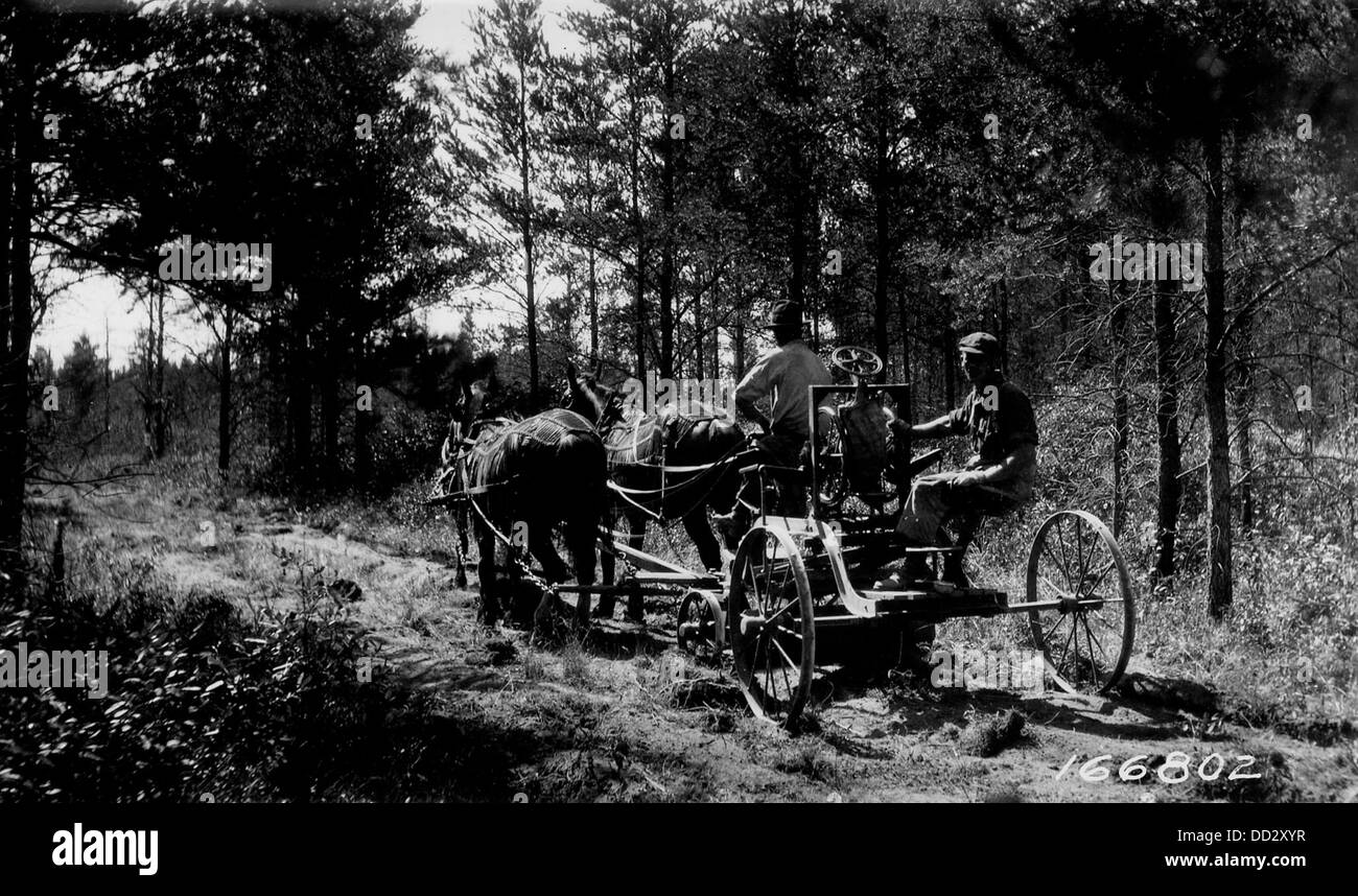 The photograph shows a road crew working for the Forest Service, likely ...