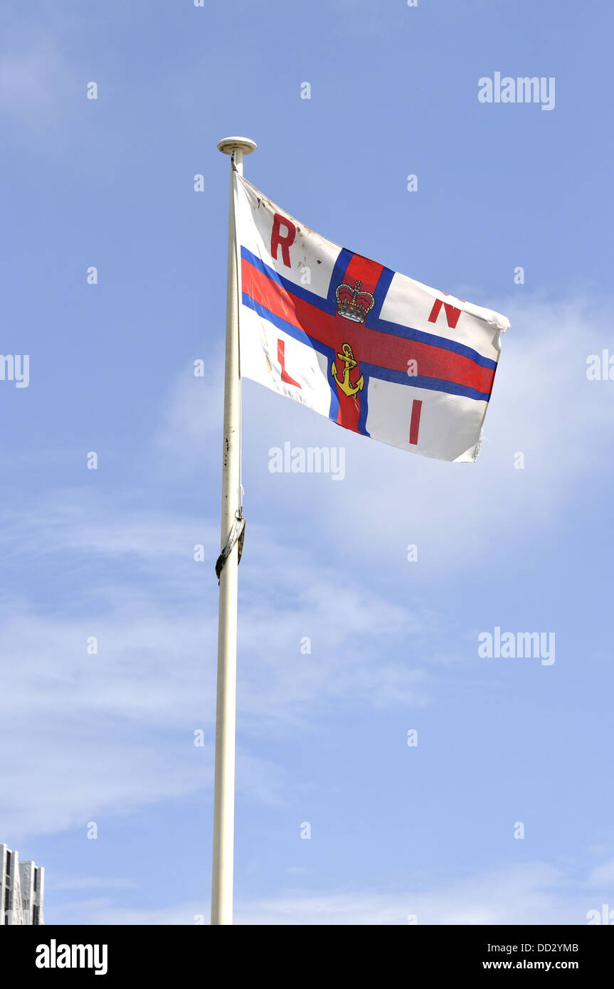 Flag of the RNLI against blue and white sky background Stock Photo - Alamy