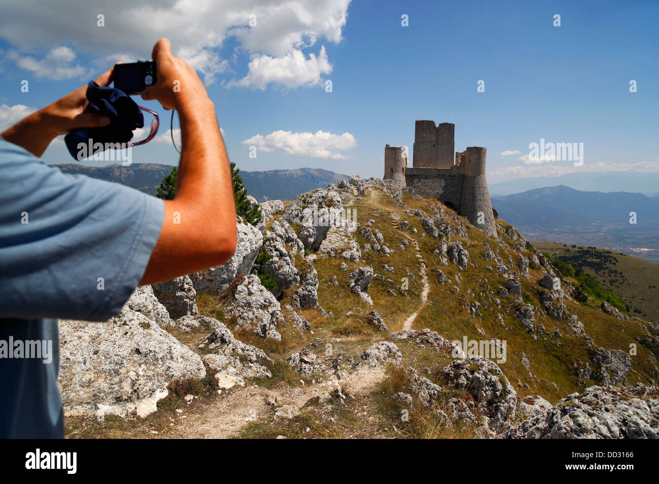 A tourist photographs the medieval castle at Rocca Calascio in Abruzzo ...