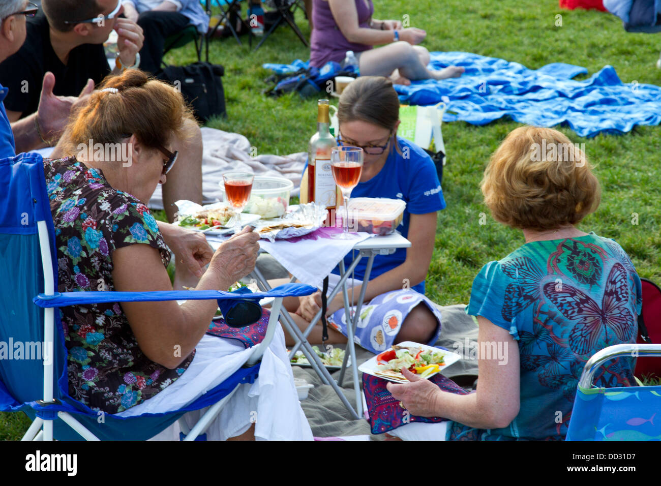 People enjoy an afternoon concert in Millennium park, Chicago, Illinois ...