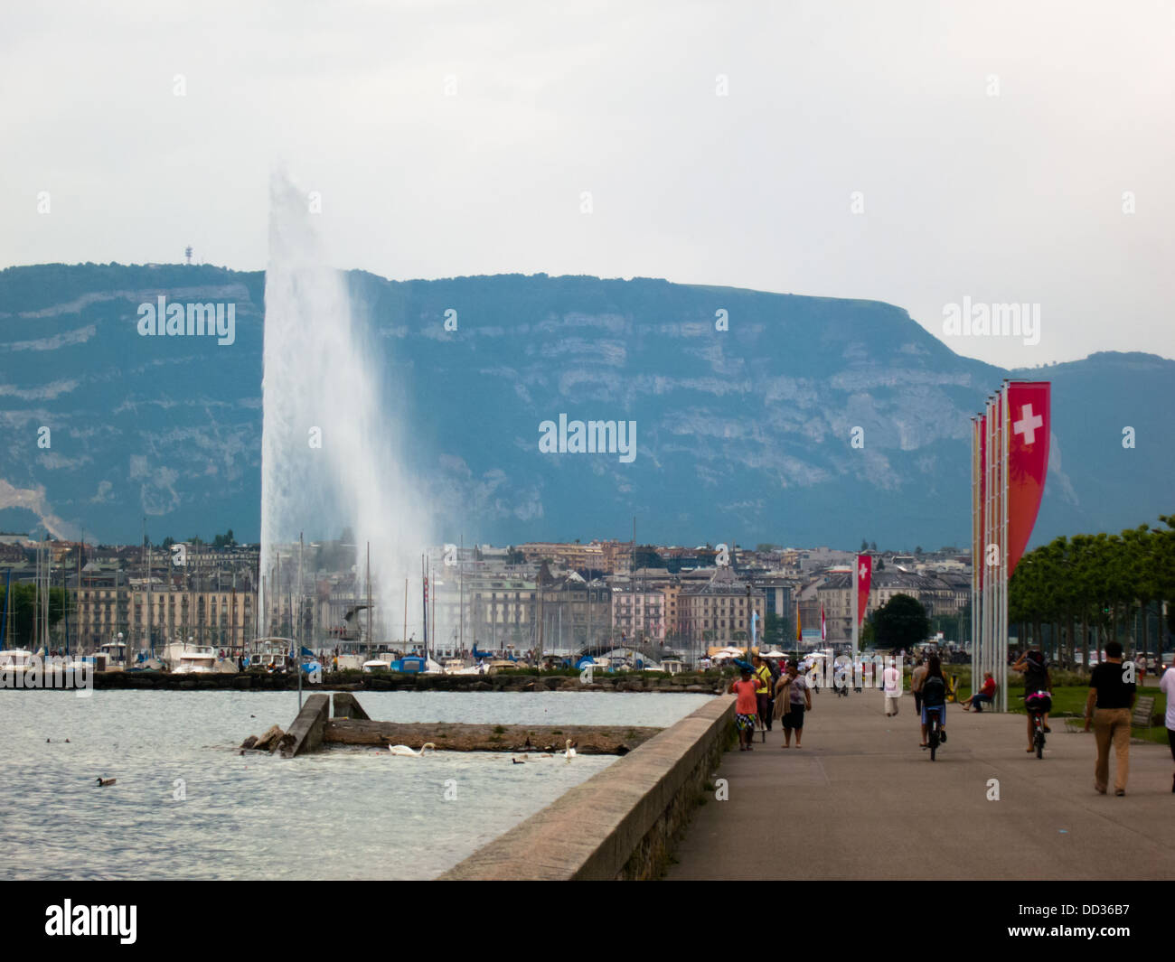 A fountain rises over the waterfront of Lake Geneva, Geneva ...