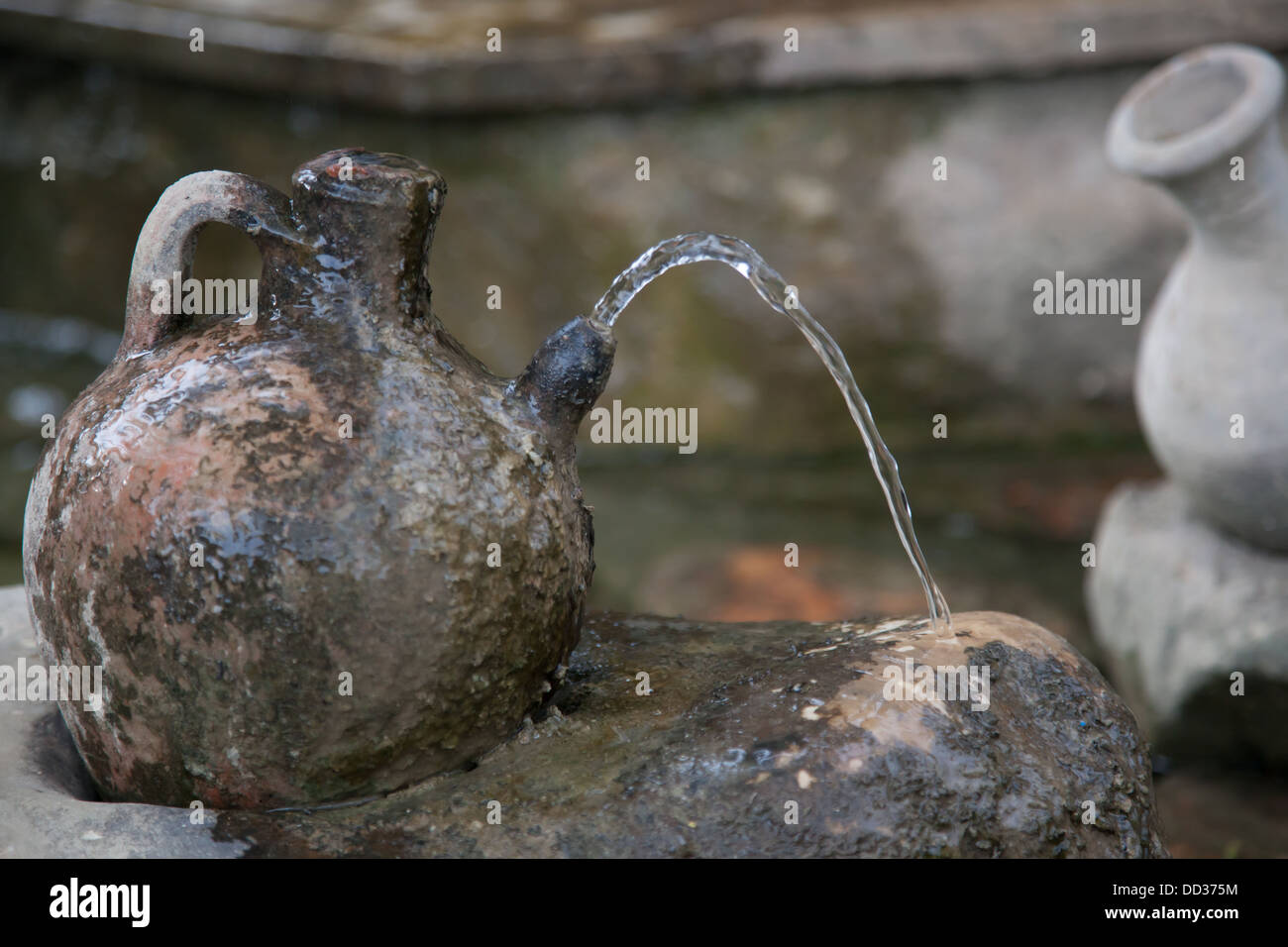 Clay Pitcher Pouring Water