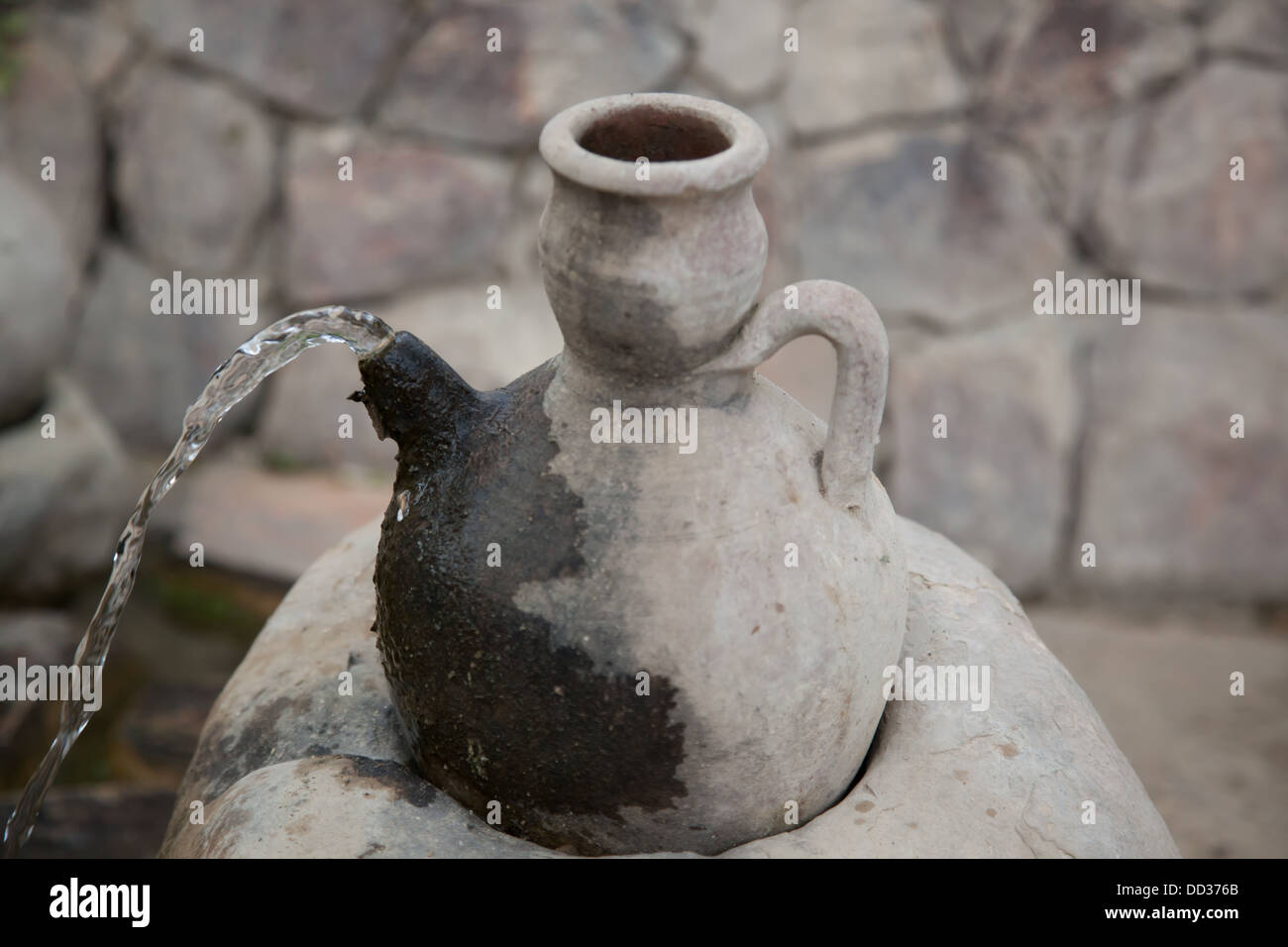 Clay pitcher with water coming out of it Stock Photo - Alamy