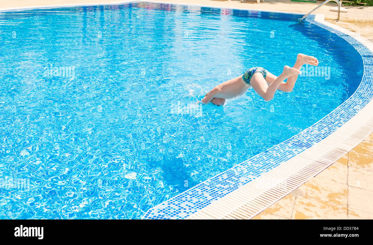 A boy jumping into swimming pool Stock Photo - Alamy