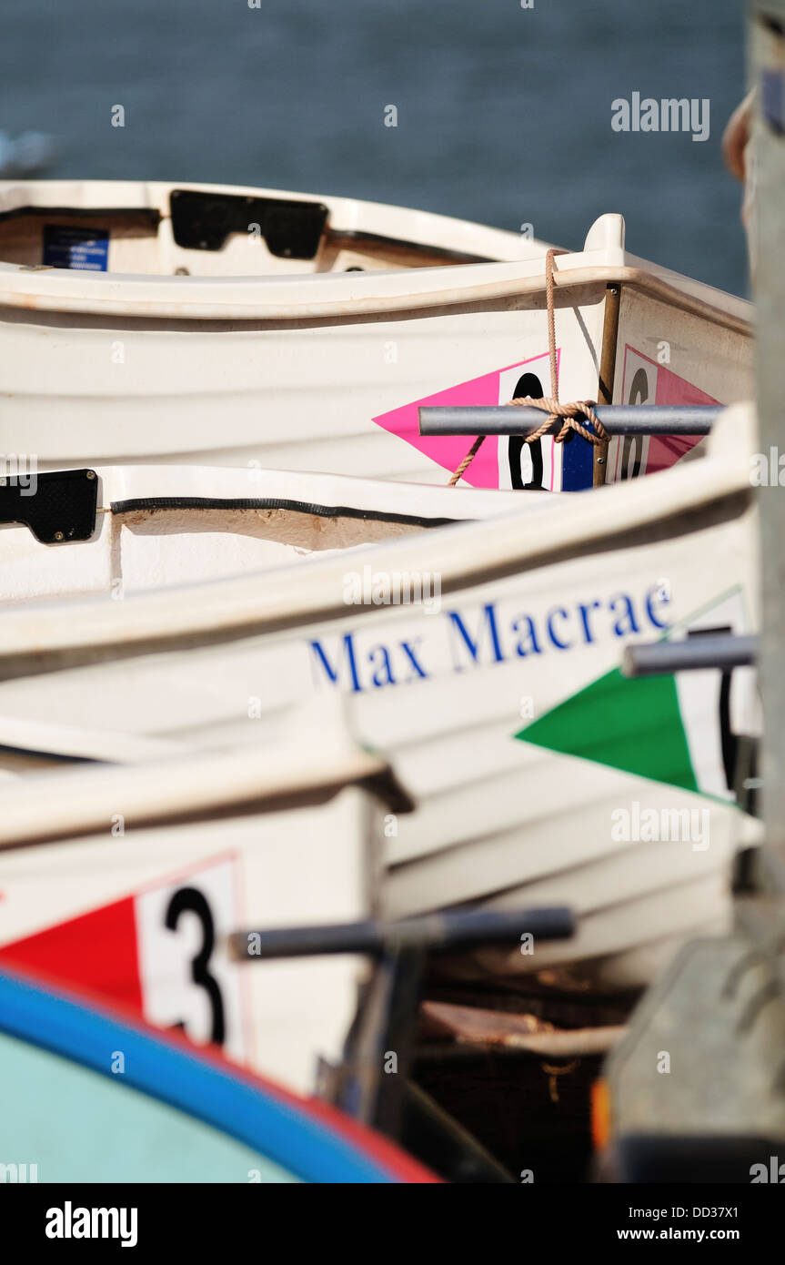 Close up of white rowing boats on the harbour side at Shaldon in Devon ...