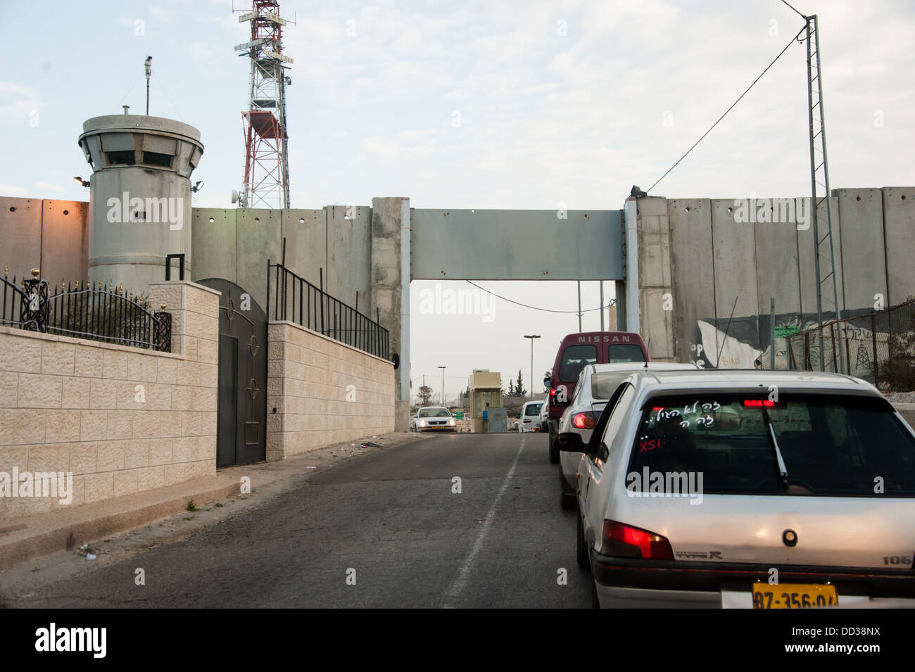 Cars wait to pass through an Israeli military checkpoint in the ...