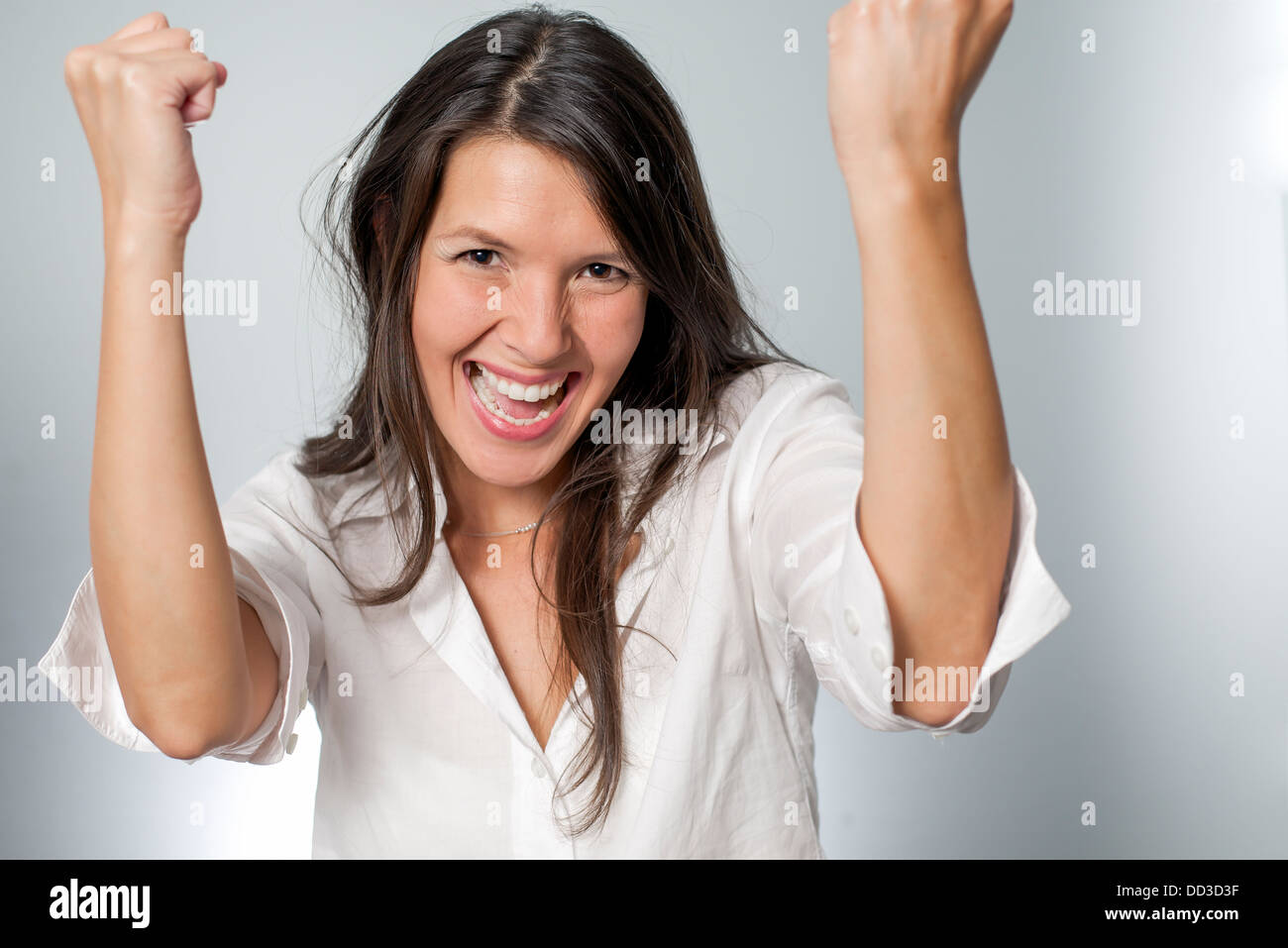 Jubilant young woman cheering her success Stock Photo - Alamy