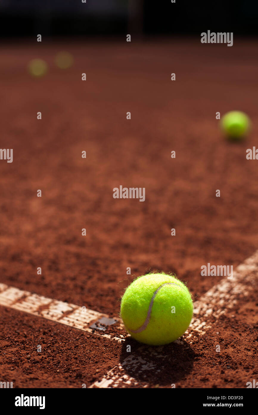 Tennis balls and rocket on court field in sunny day Stock Photo - Alamy