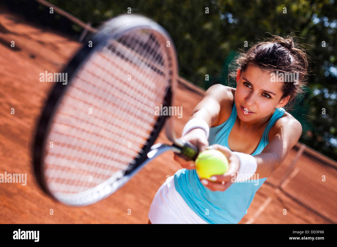 Young girl catching a ball in tennis court in pretty day Stock Photo ...