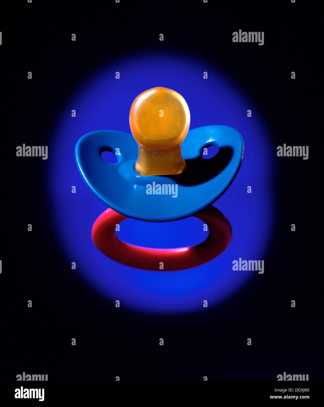 A baby's pacifier in a spotlight Stock Photo - Alamy