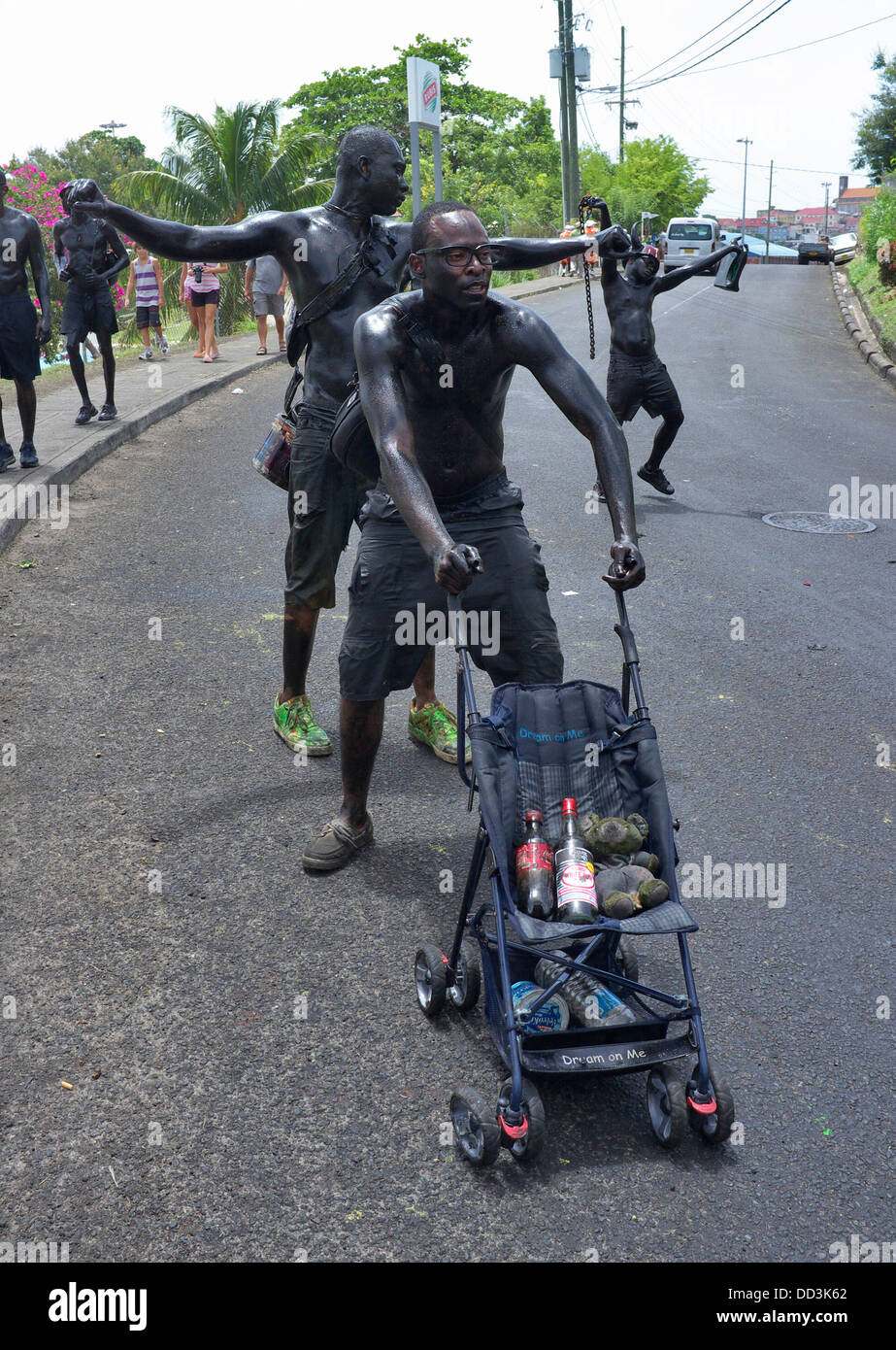 Grenada’s Caribbean annual carnival Jab Jab revelers have painted their ...