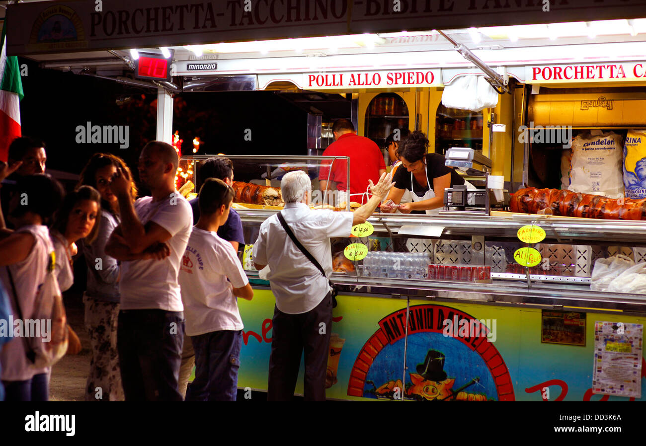 Customers queue for take-away food being sold at a festival in the ...