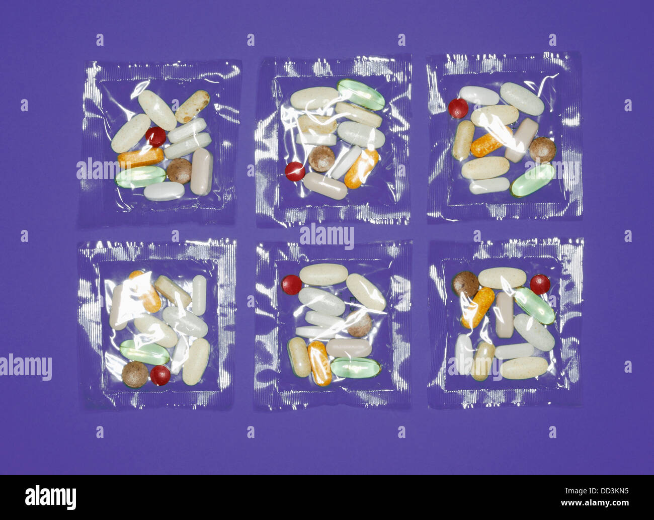 A plastic clear packets of vitamin supplements - pills, capsules and ...