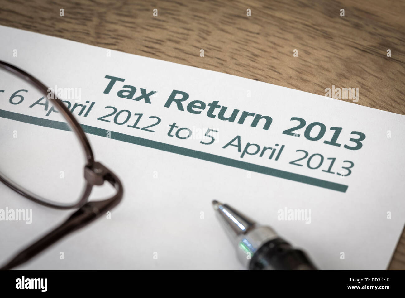 UK Income tax return form for 2013 on a desk with pen and glasses Stock ...