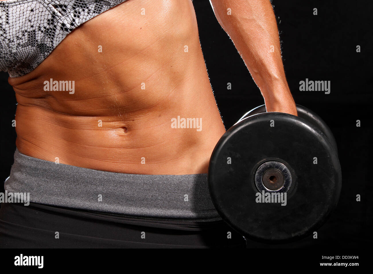 Attractive young woman working out with weights Stock Photo - Alamy