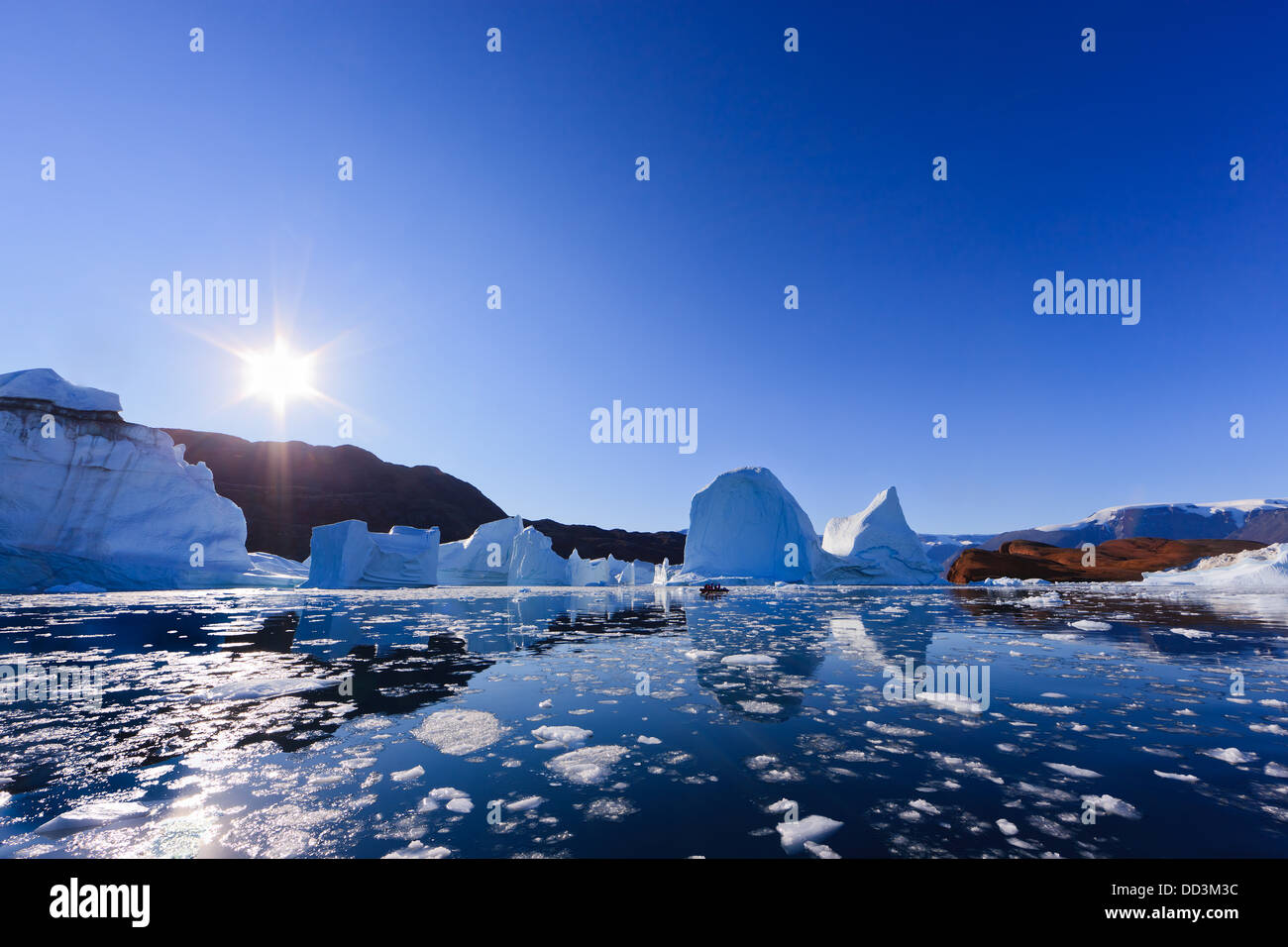 Cruising between the icebergs at Røde Ø, Scoresby sund, Greenland Stock ...