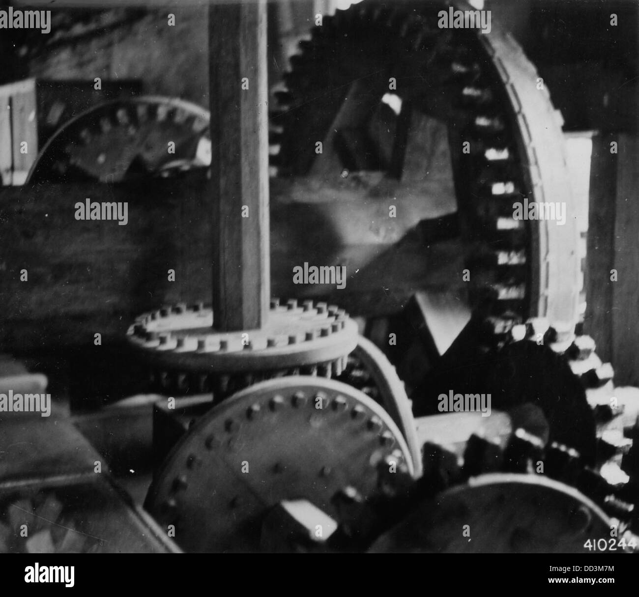 A close-up image of the wooden gears inside a grist mill, highlighting ...