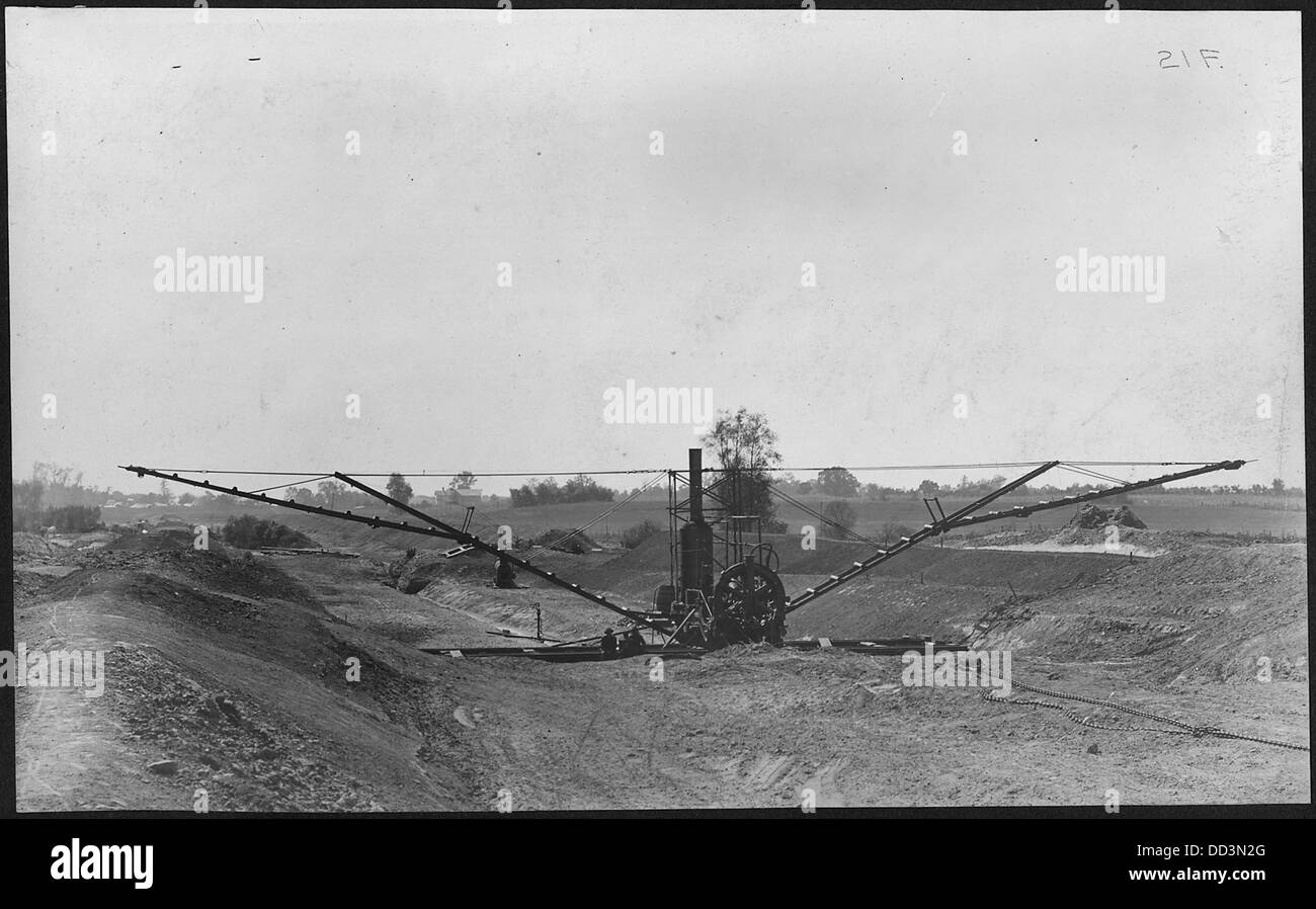 This historical photograph shows a general view of an auger machine ...