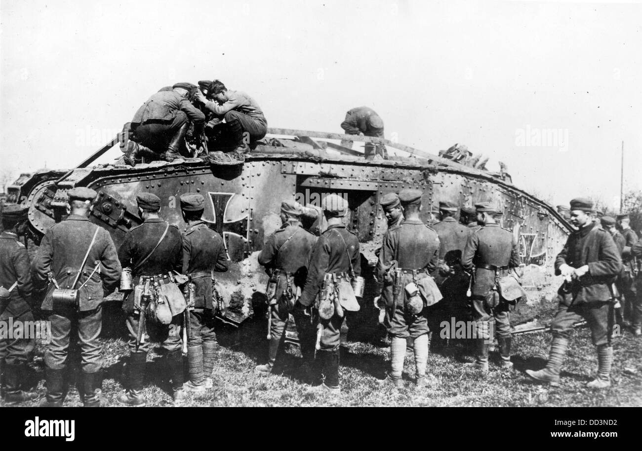 German soldiers standing around a German tank as other soldiers work on ...