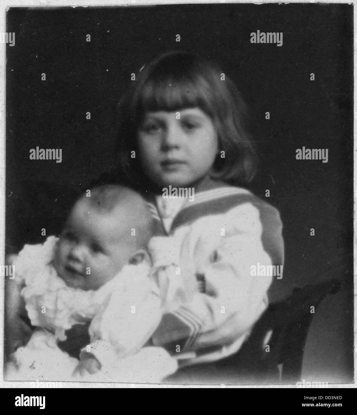 A simple portrait of two children, captured in a quiet, intimate moment ...