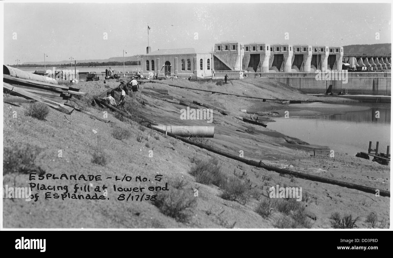 A photograph showing the construction process of placing fill at the ...