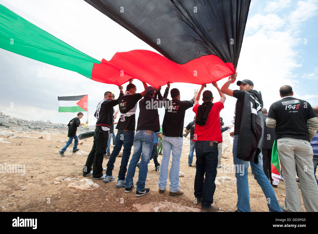 Palestinian activists carry a giant flag while commemorating Nakba Day ...
