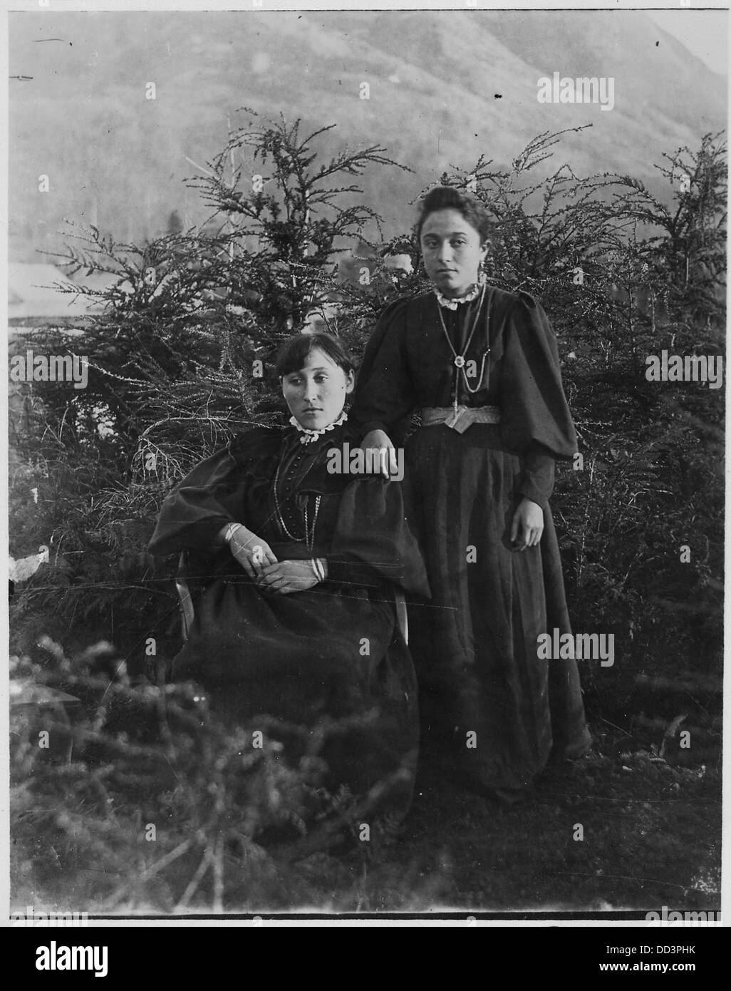 This photograph depicts two young Native American women, captured in ...