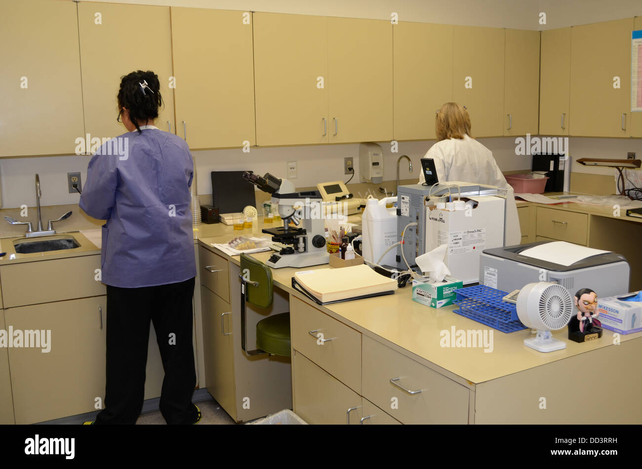 Female staff at work in prison laboratory testing samples from inmate ...