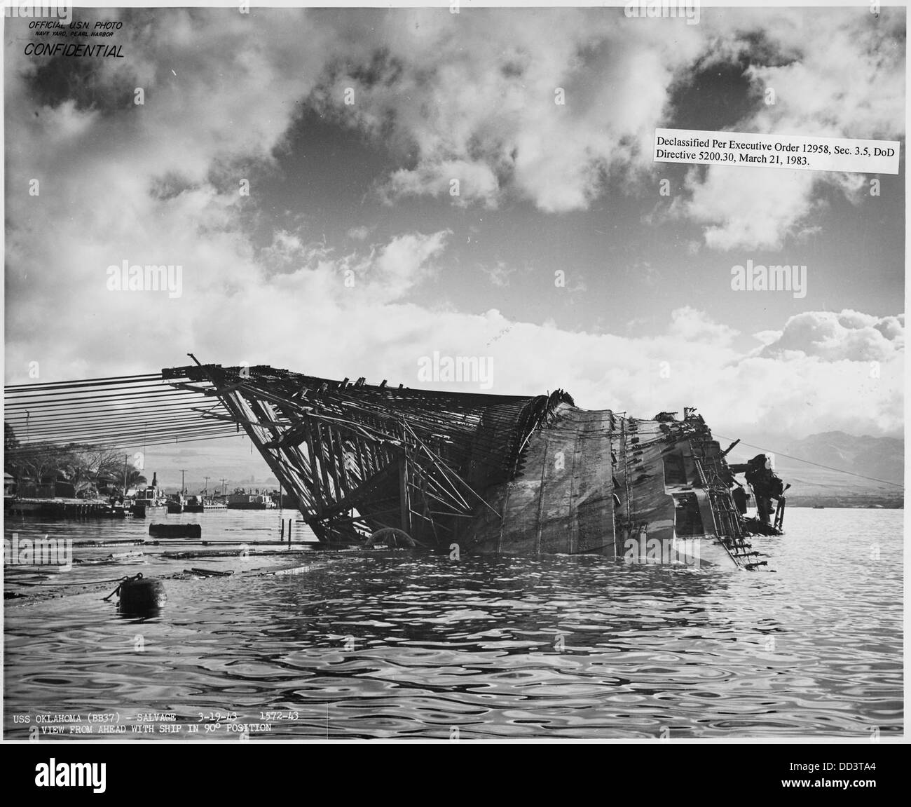 This image shows the salvage operation of the USS Oklahoma (BB37) on ...