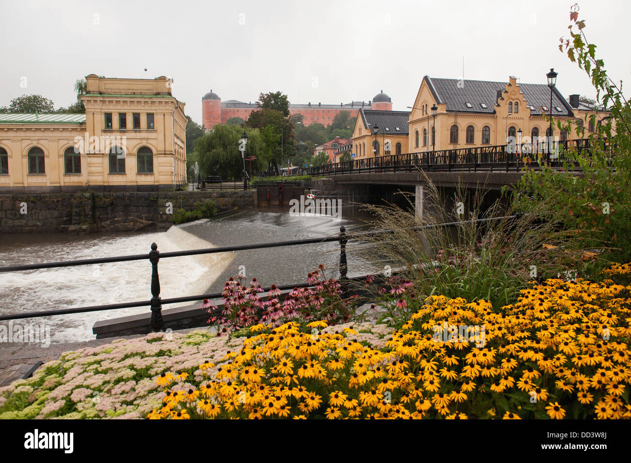 Fyris River And Pump House With Colourful Flowers In The Foreground; Uppsala, Sweden Stock Photo ...