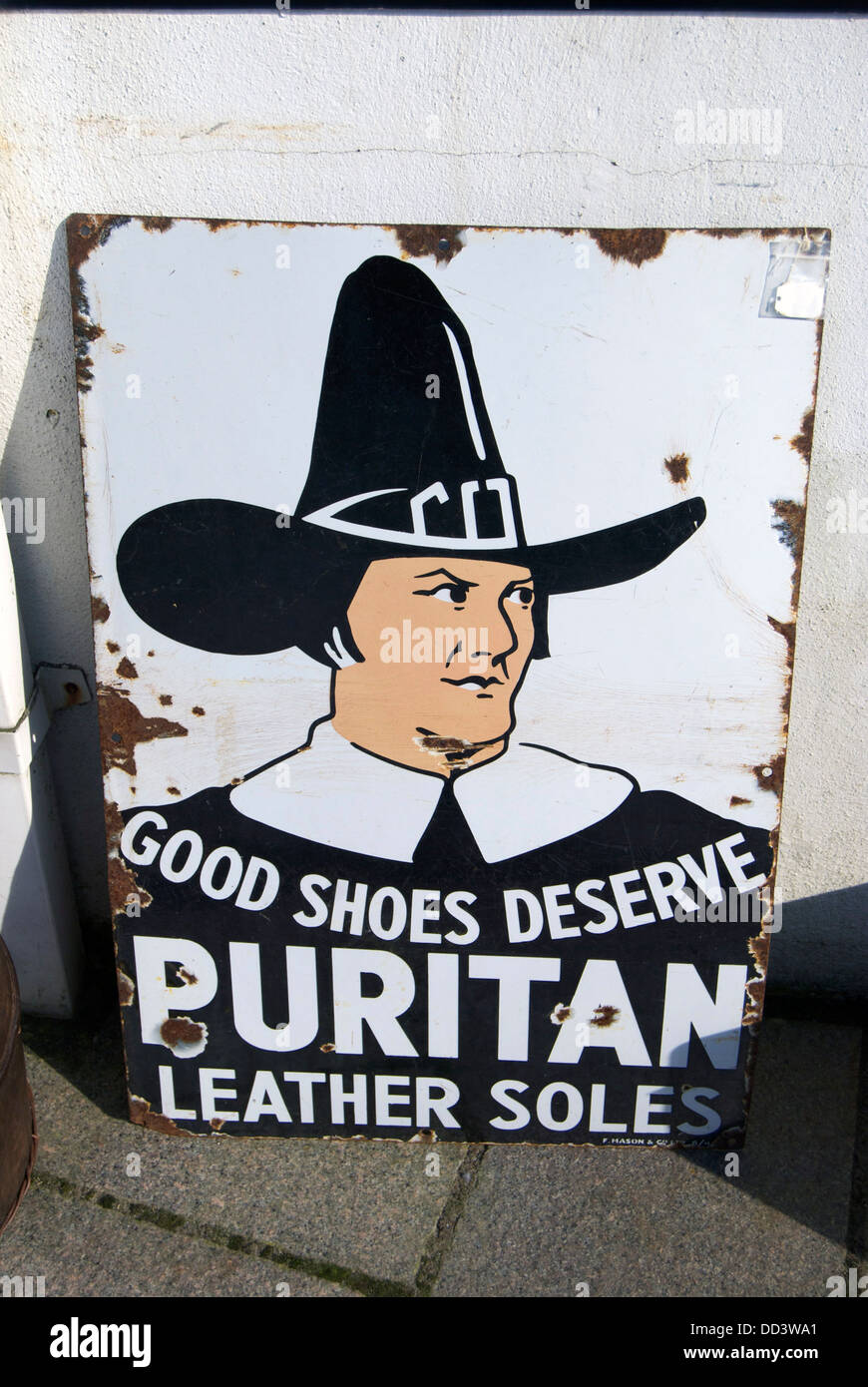 An old metal advertising sign for Puritan Leather Soles Stock Photo - Alamy