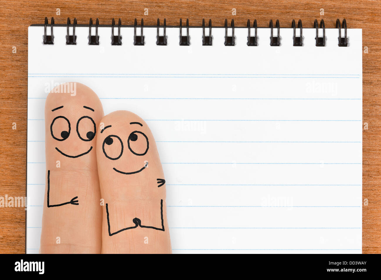 Happy Finger Face Couple with Blank Notepad Copy Space Stock Photo - Alamy