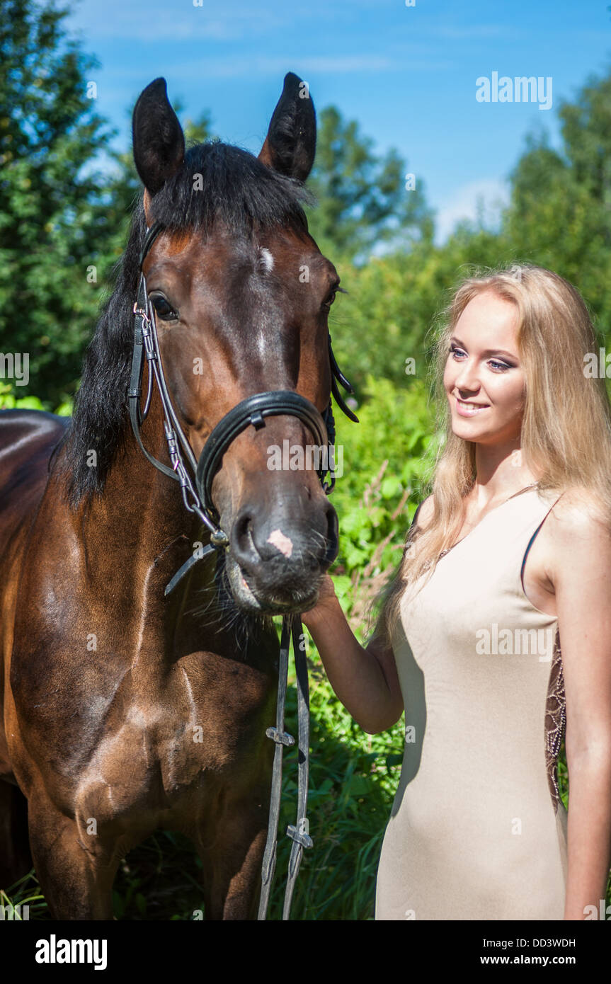 Young pretty girl and a horse in the forest Stock Photo - Alamy
